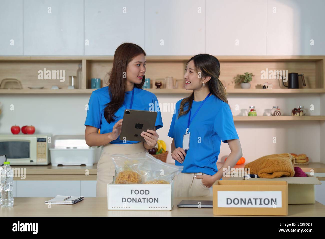 Food Donation Process. Volunteers discussing food items for community ...