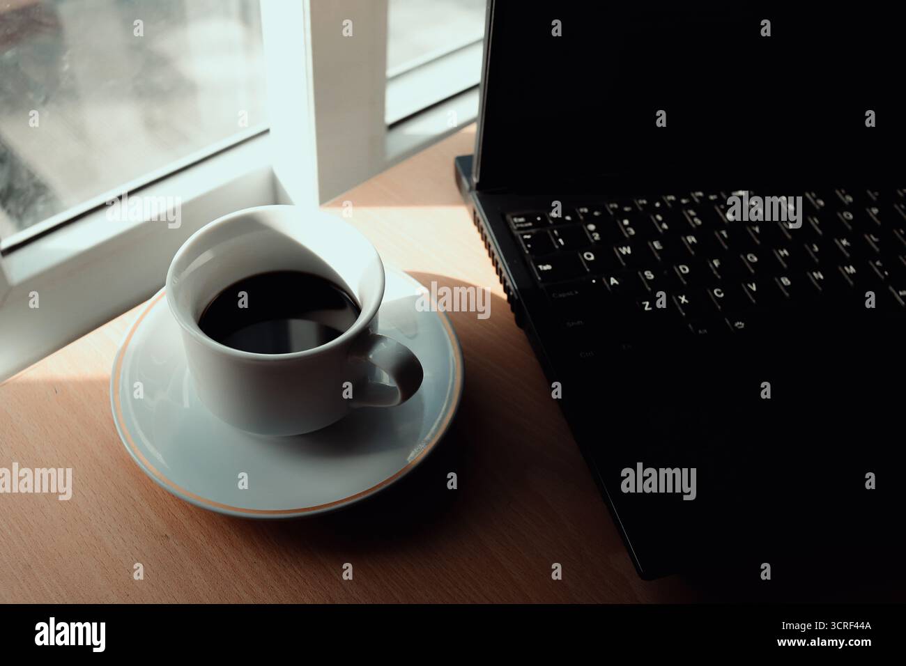 Cup of coffee and laptop on vintage iron table Stock Photo - Alamy