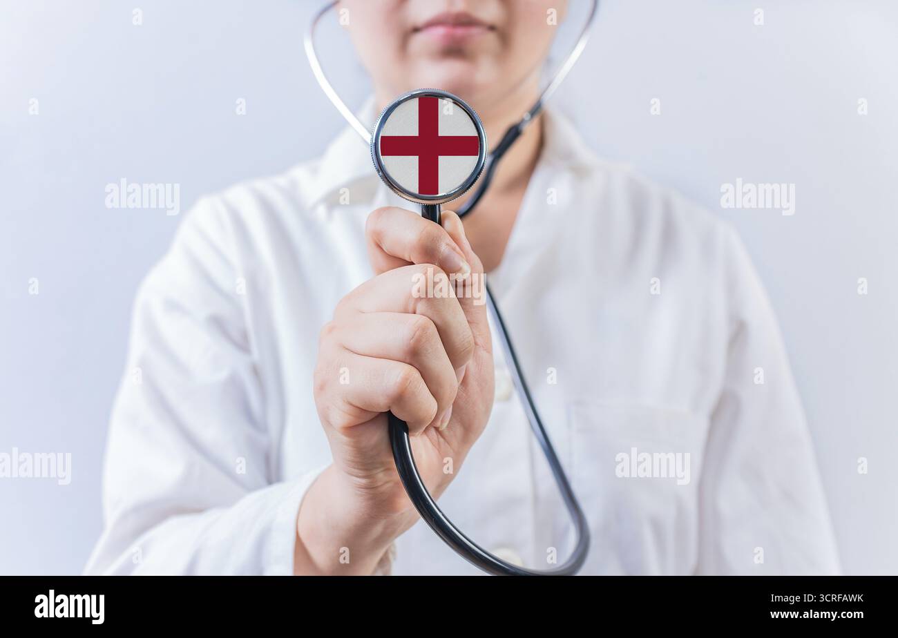 Female doctor holding stethoscope with England flag. National health ...