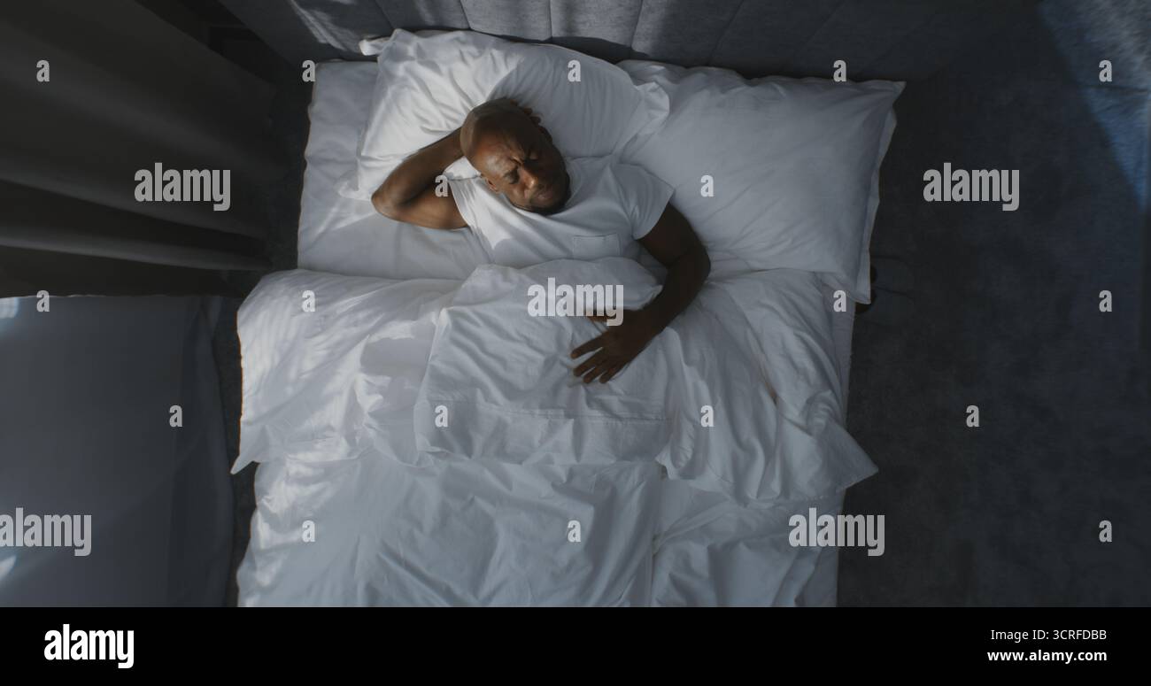 African American Man Wakes Up in Morning and Squints in Bright Sunlight ...