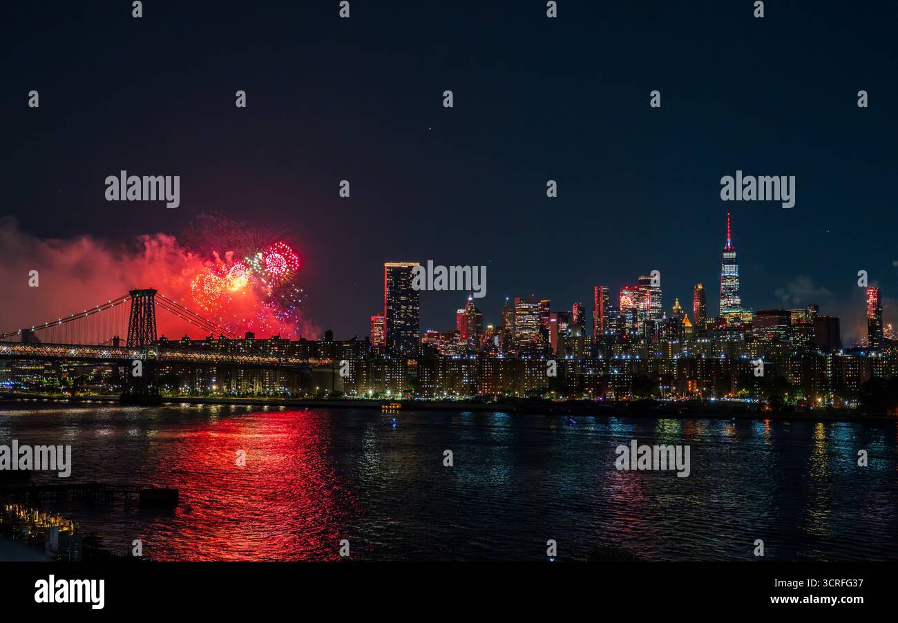 July 4th. View of vibrant fireworks exploding over the dark waters ...