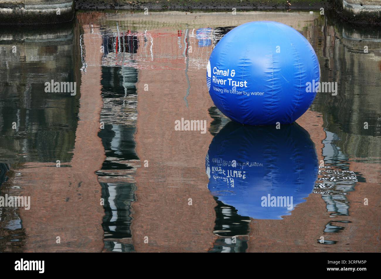 Blue Canal & River Trust inflatable buoy floats on calm water, with its ...