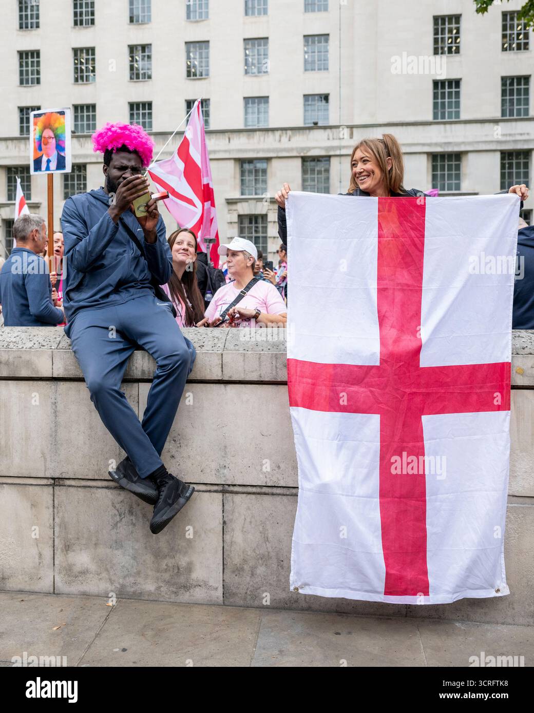 London, UK. 1 October 2025. People take part in a ‘pink protest’ in ...