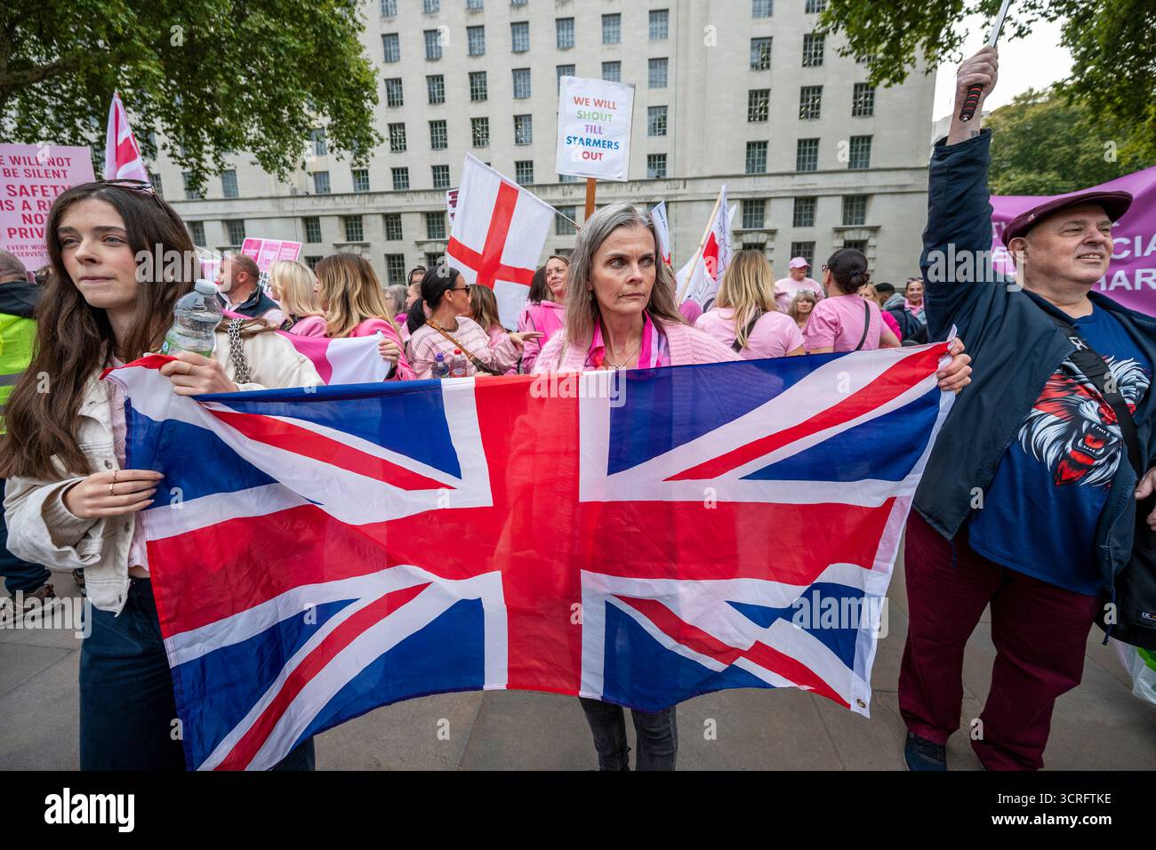London, UK. 1 October 2025. People take part in a ‘pink protest’ in ...