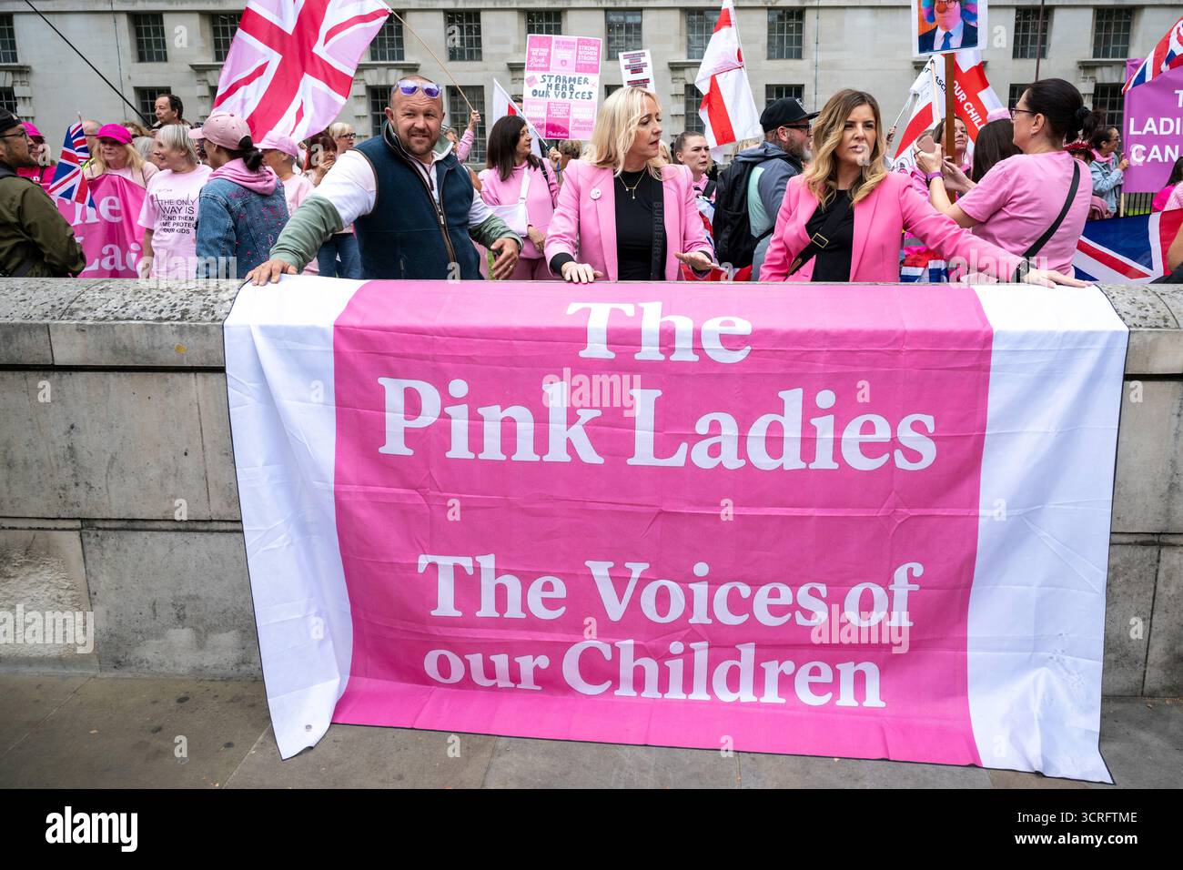 London, UK. 1 October 2025. People take part in a ‘pink protest’ in ...