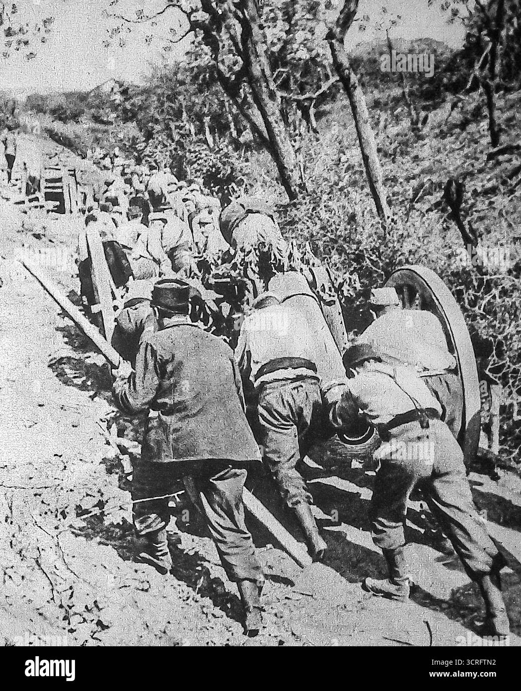 World War I Italian troops push a 155mm short cannon through a rough ...