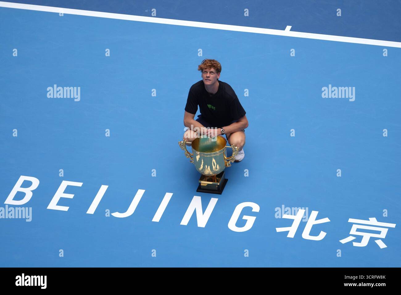 Jannik Sinner of Italy reacts with his trophy after defeating Learner ...