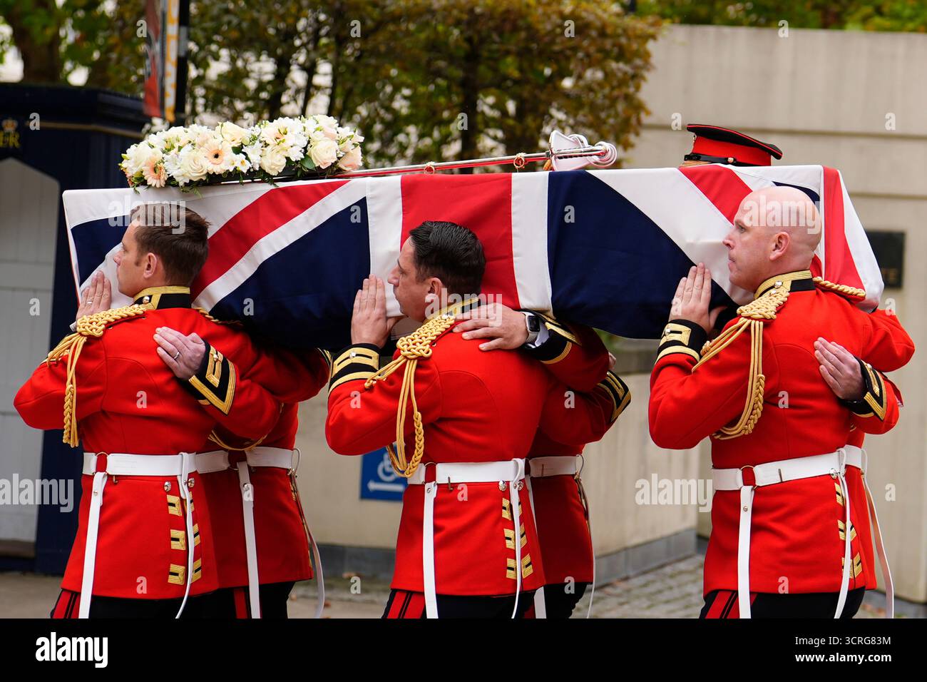 The Bearer Party carry the coffin in to the funeral for Captain ...