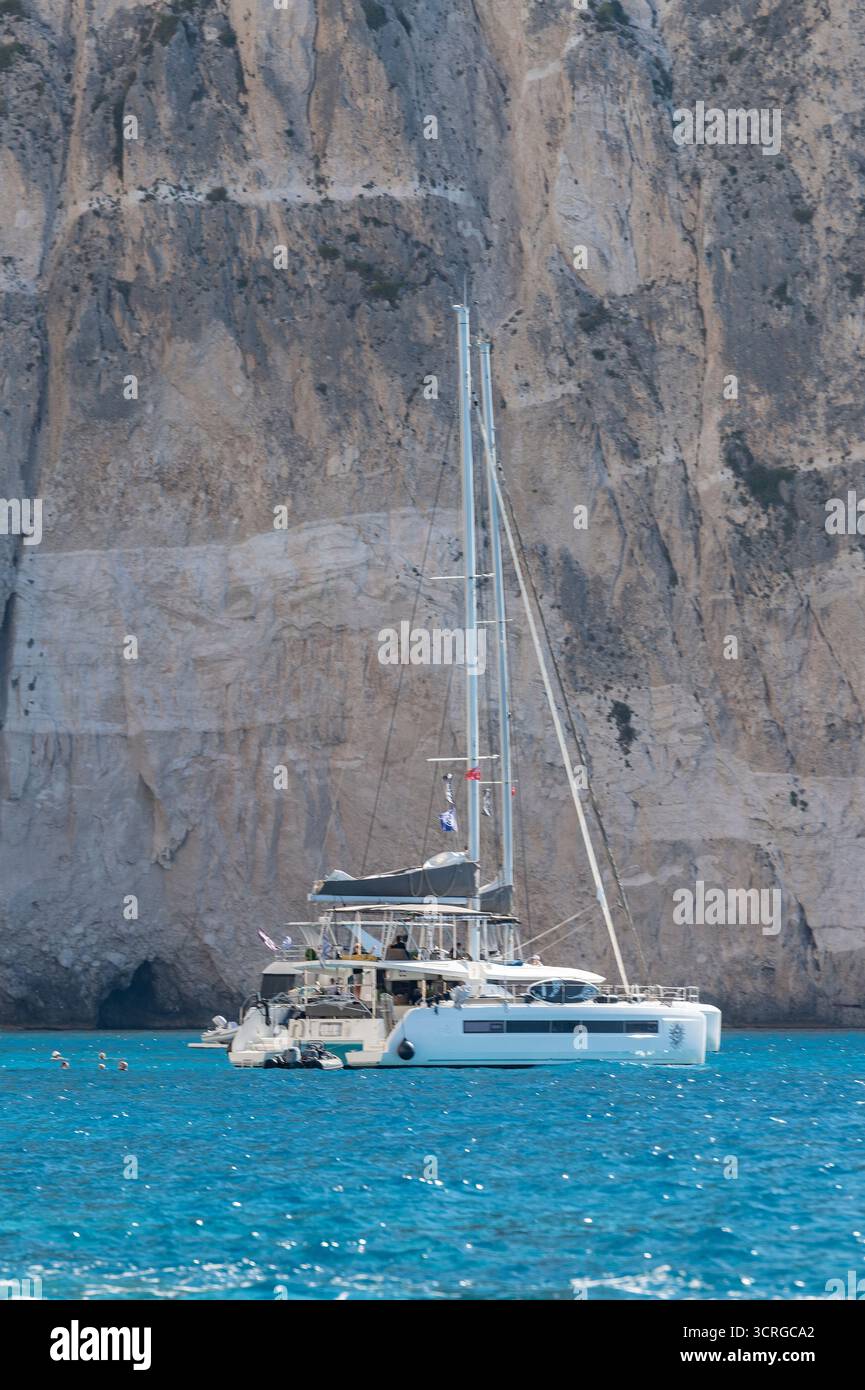 large luxury catamaran anchored in an idyllic mediterranean bay with ...