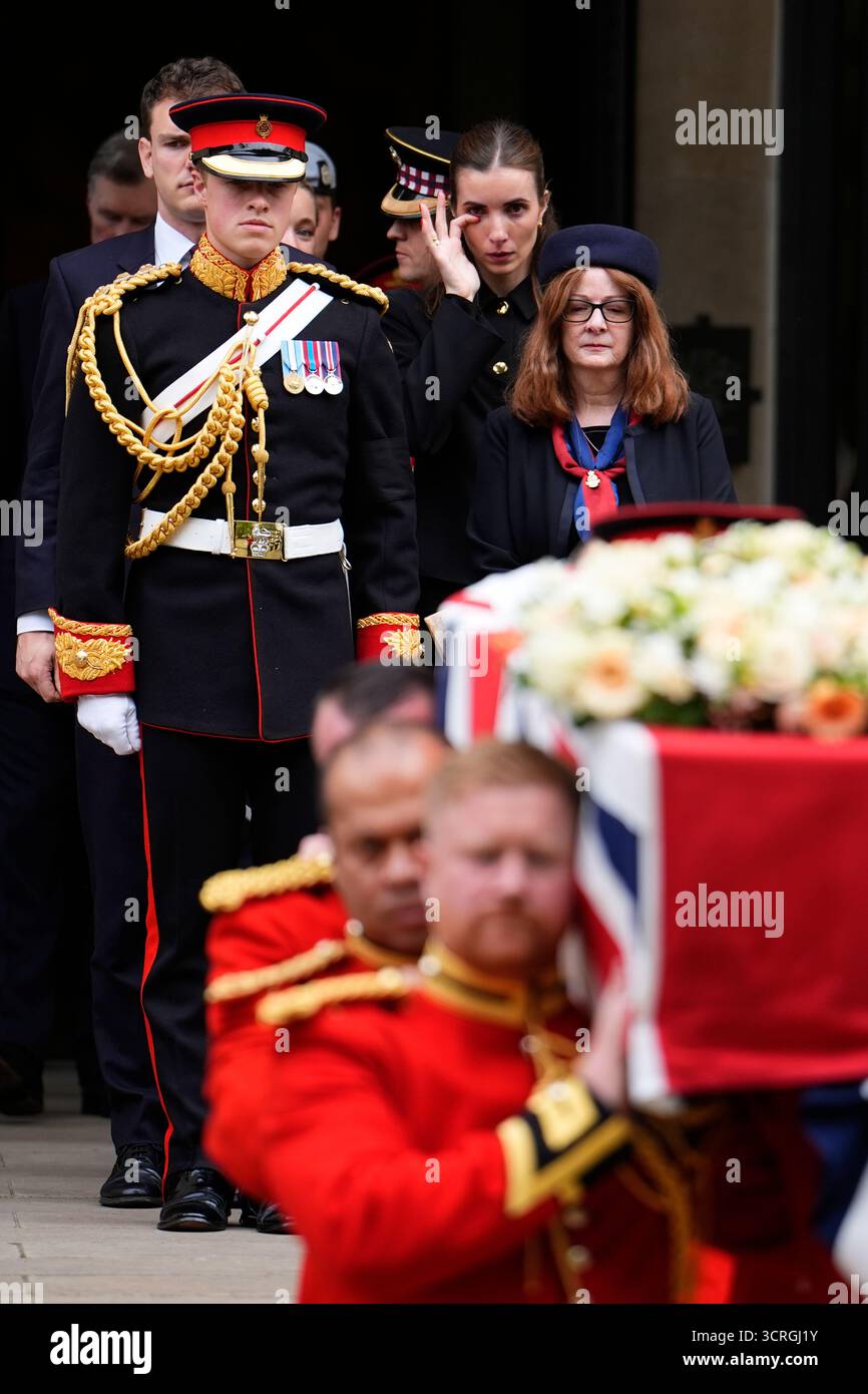 Family members watch as the Bearer Party carry the coffin from the ...
