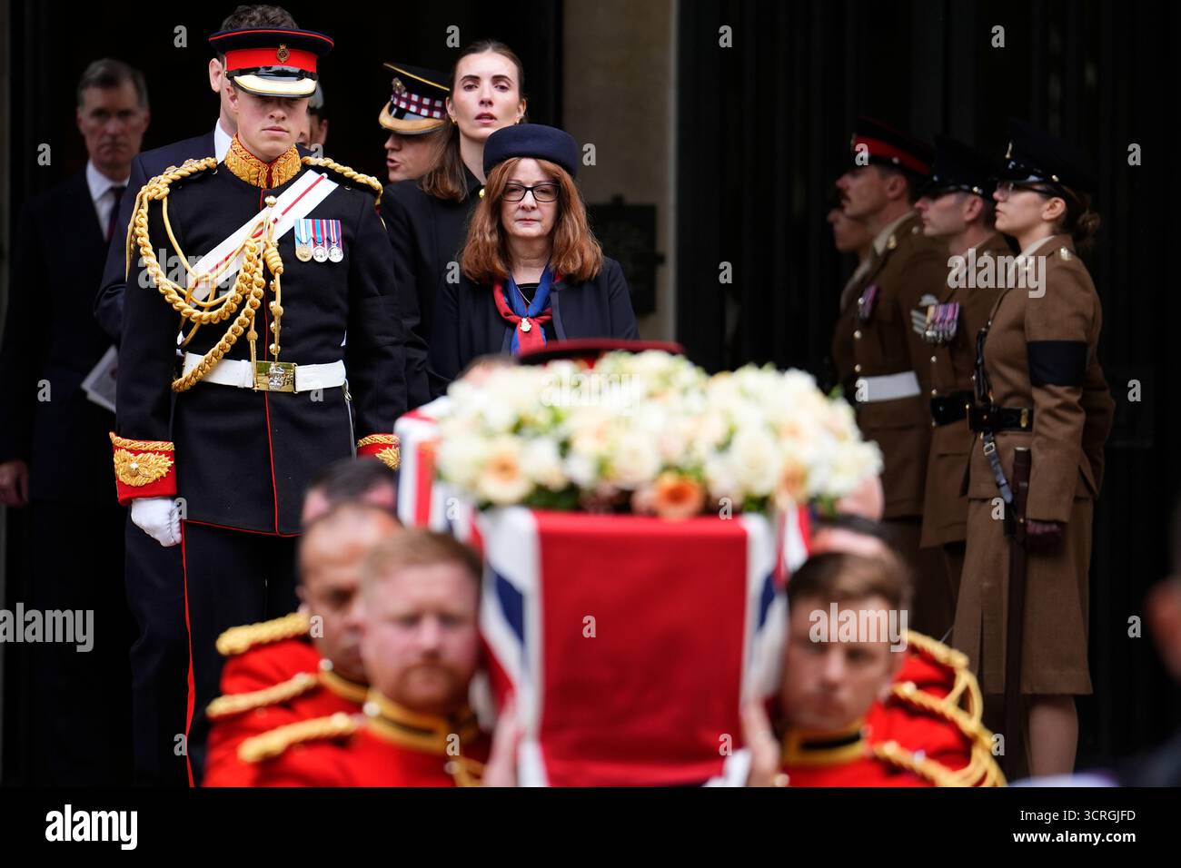 Family members watch as the Bearer Party carry the coffin from the ...
