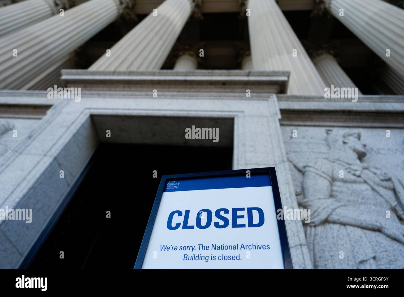 A closed sign stands in front of the National Archives on the first day ...
