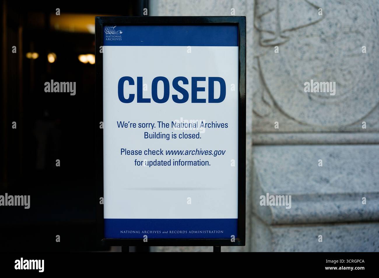 A closed sign stands in front of the National Archives on the first day ...