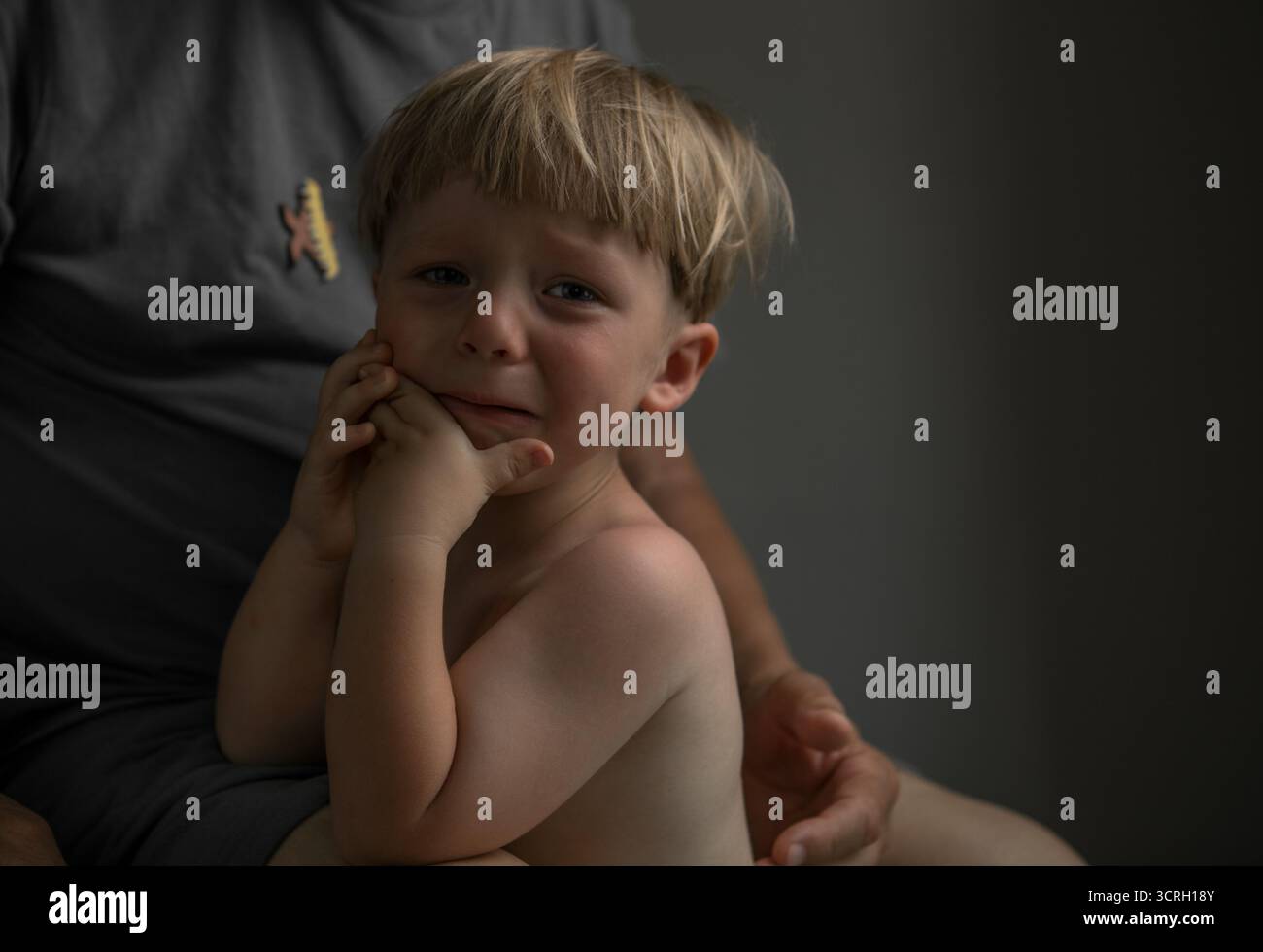 Crying boy with grandfather Stock Photo - Alamy
