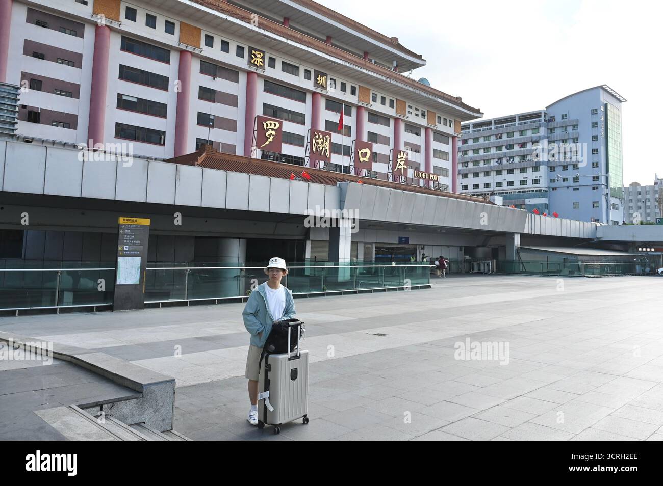 A man waiting at Luohu Port on October 1, 2025 in Shenzhen, China ...