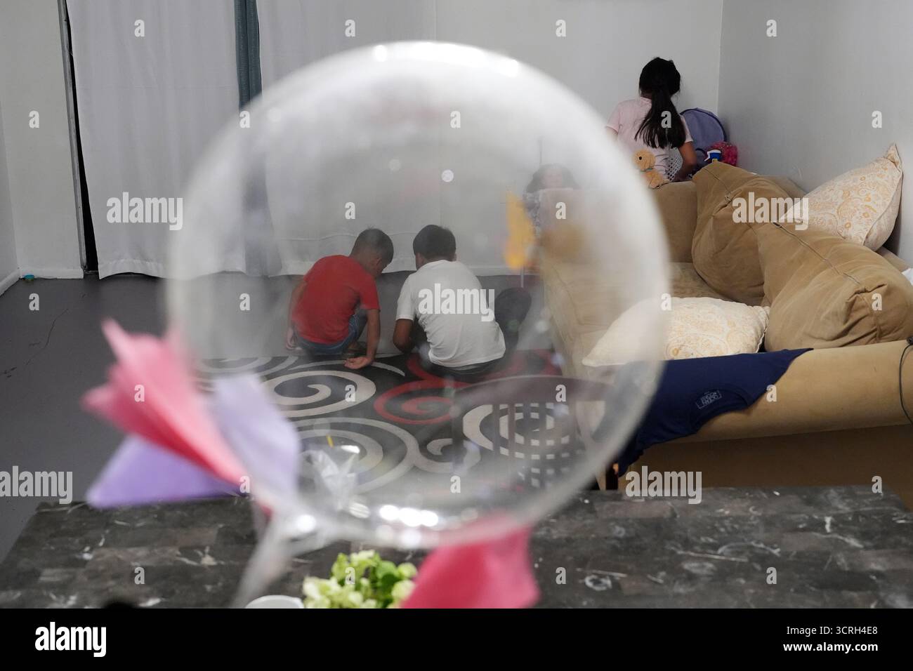 Mexican asylum-seeker Blanca's three young children play inside the ...