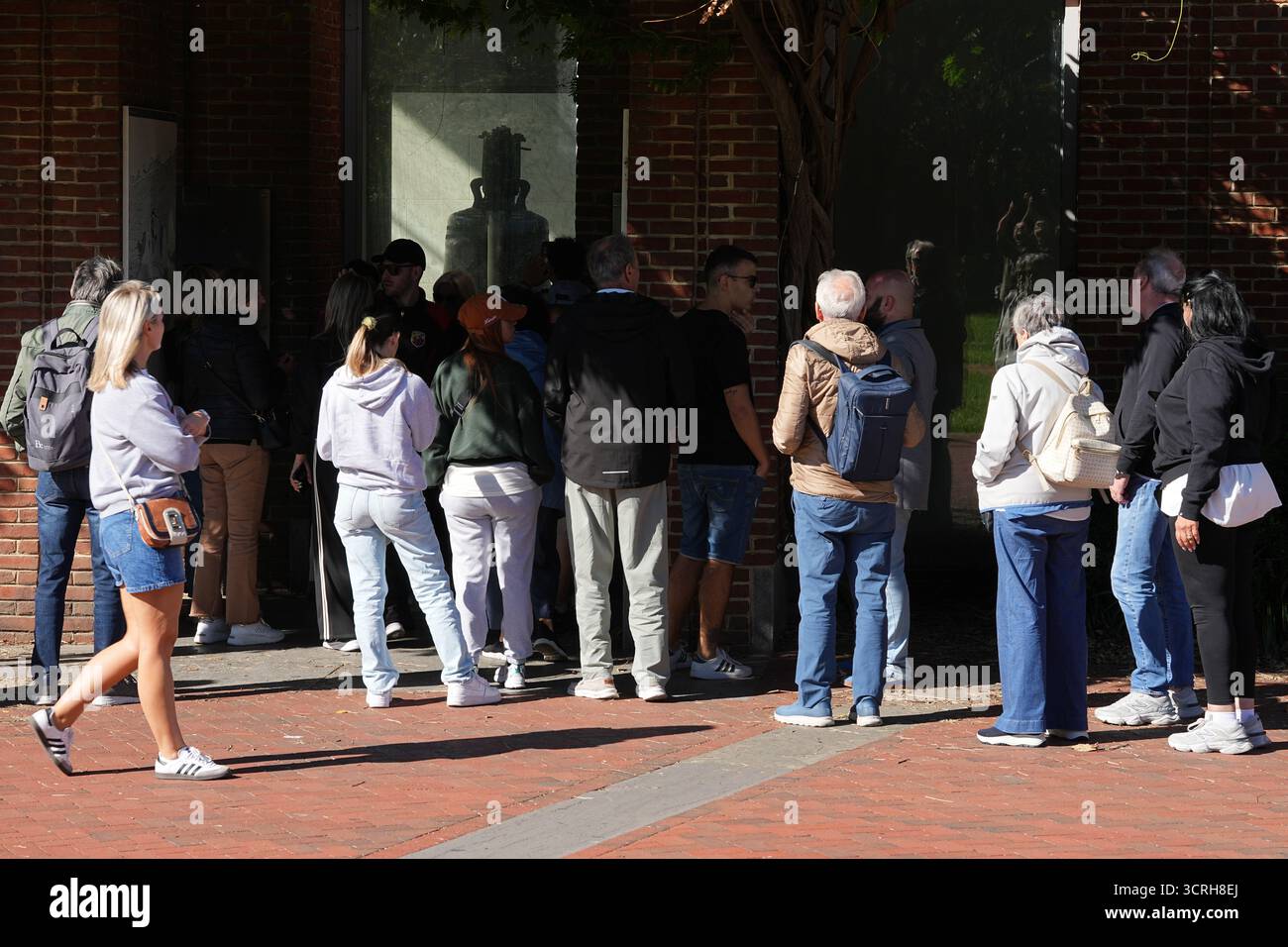 Tourist crowd around a window to view the Liberty Bell in Philadelphia ...