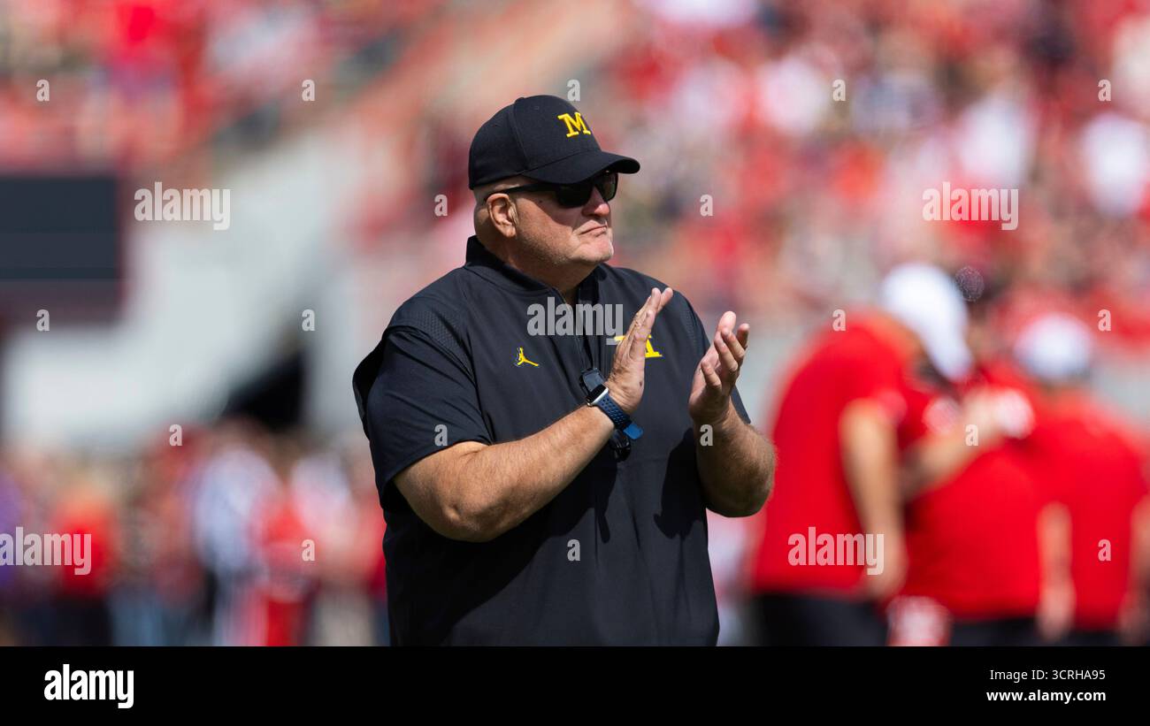 Michigan acting head coach Biff Poggi watches his team warm up before ...