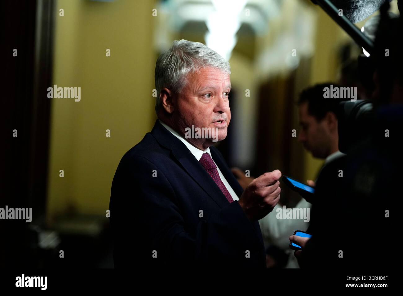 Liberal MP Terry Sheehan answers questions as he makes his way to a ...