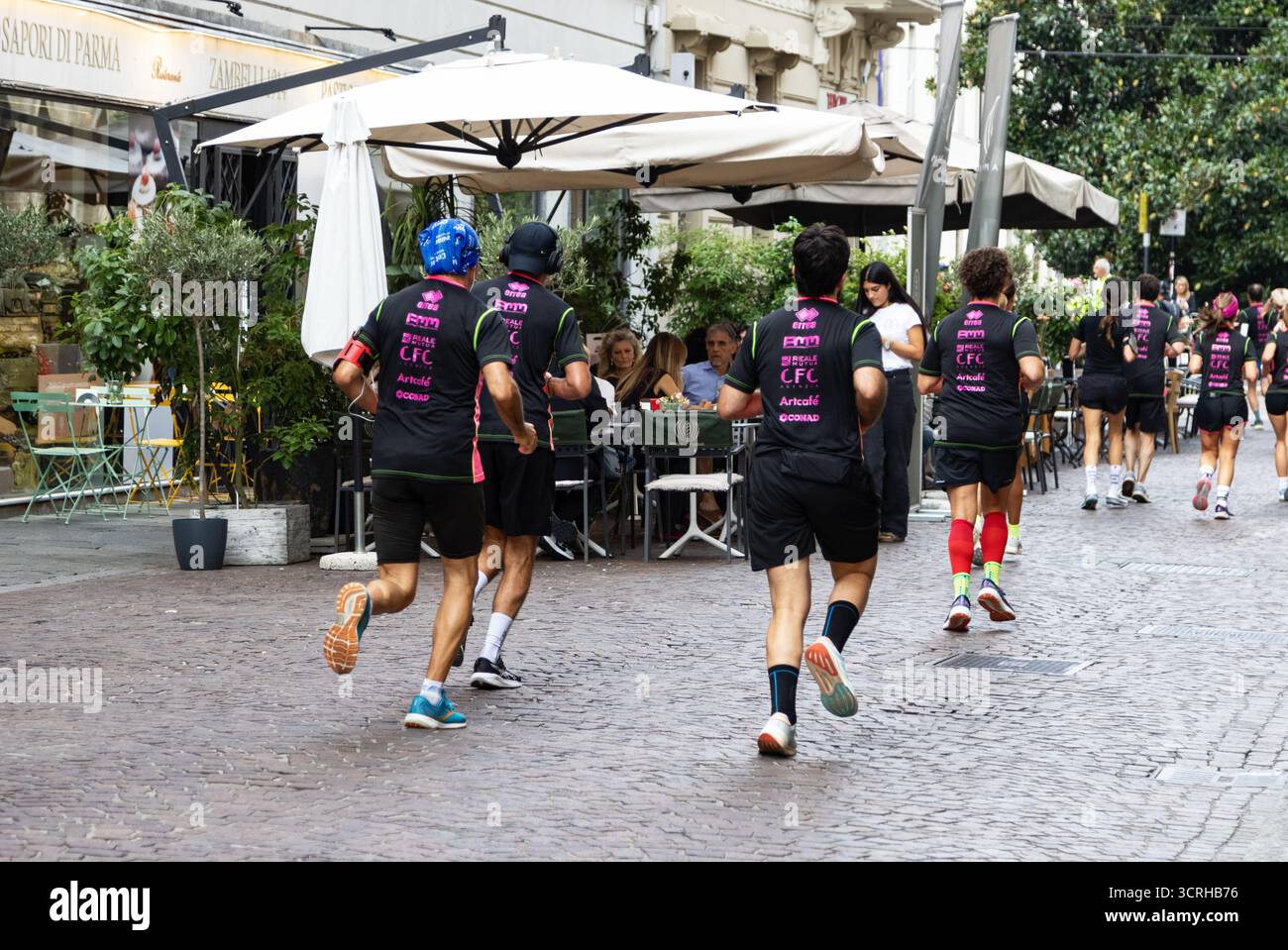 Marathon athletes turn a city corner showing endurance determination ...