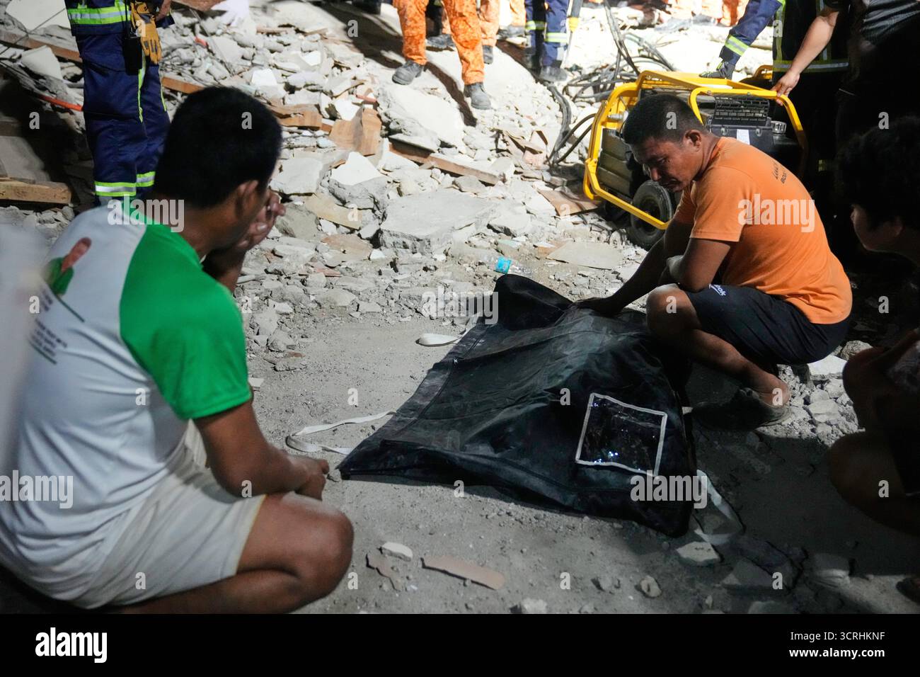 Isagani Geliig, right, touches the body of his son that was recovered ...