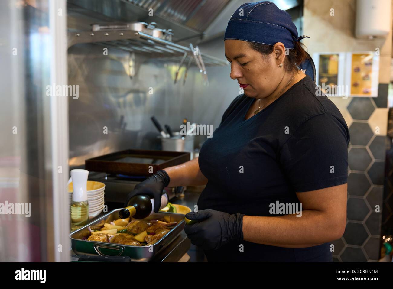 Woman chef adding wine hi-res stock photography and images - Alamy