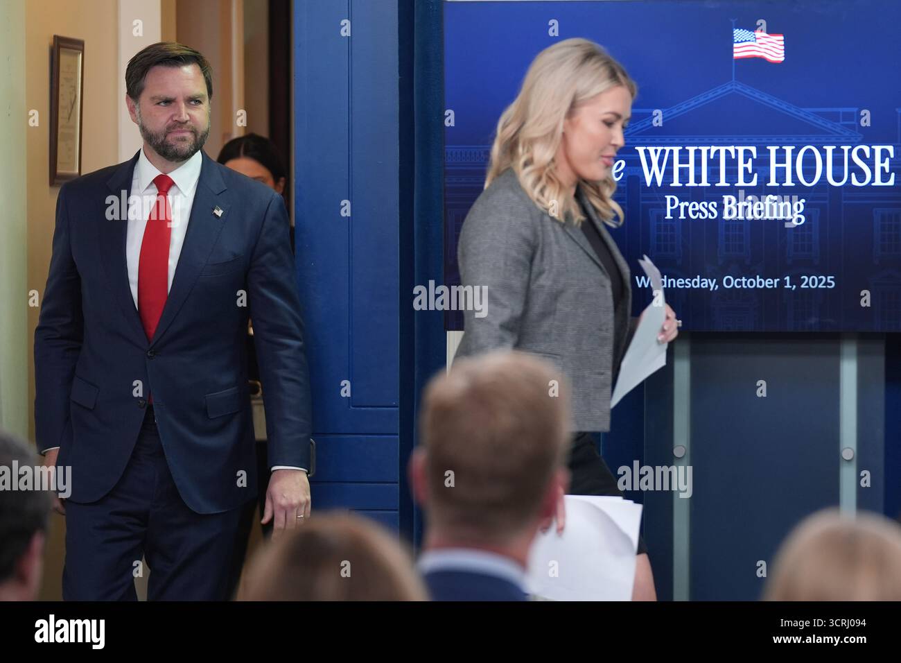 Vice President JD Vance, left, and White House press secretary Karoline Leavitt, right, walking ...