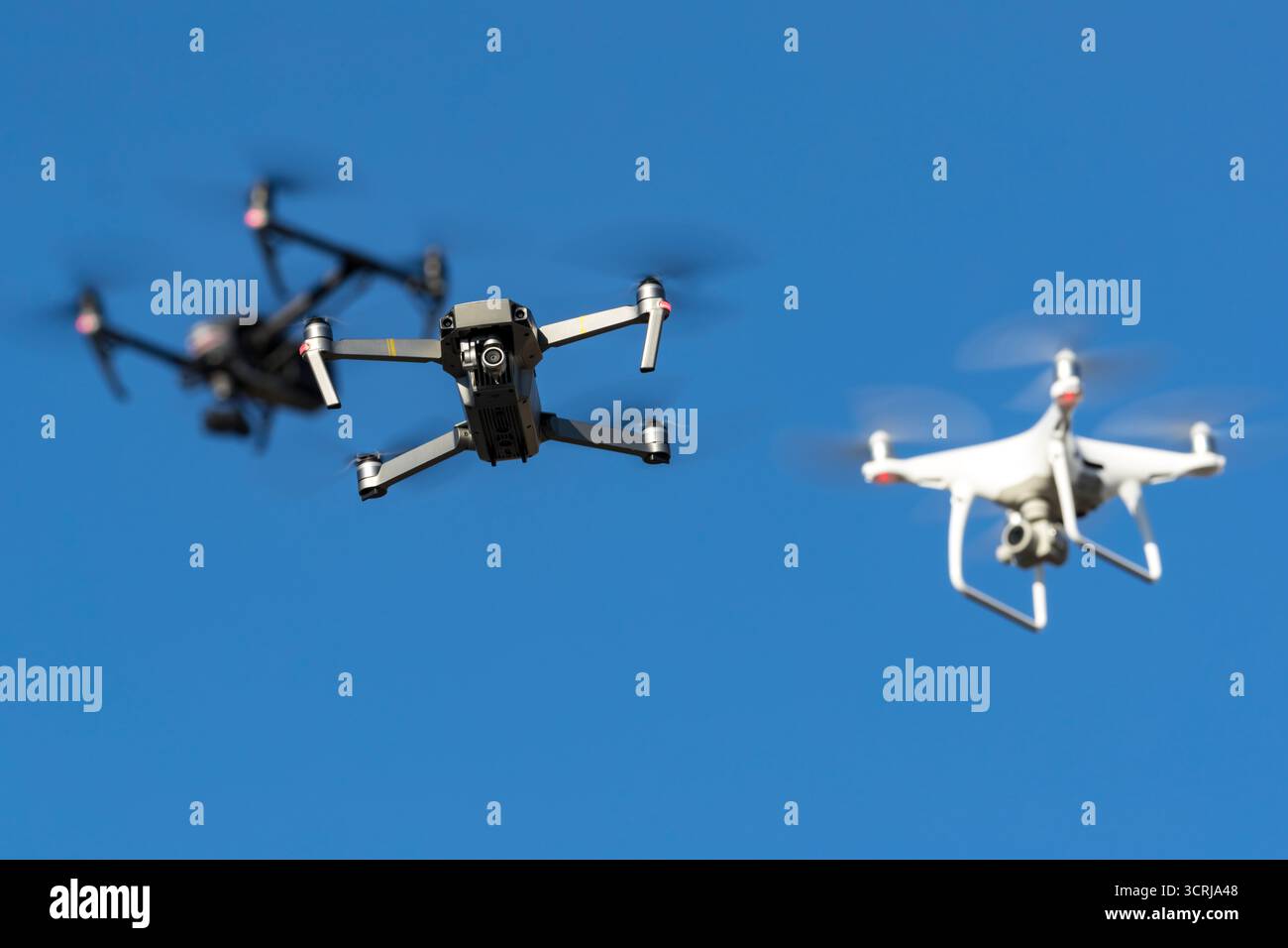 A diverse fleet of drones of all sizes and weights soars through a ...
