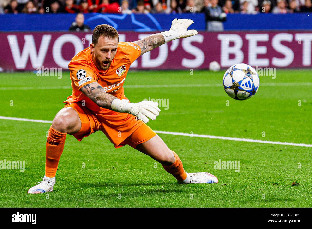 Goalkeeper Mark Flekken of Bayer 04 Leverkusen goes for the ball during ...