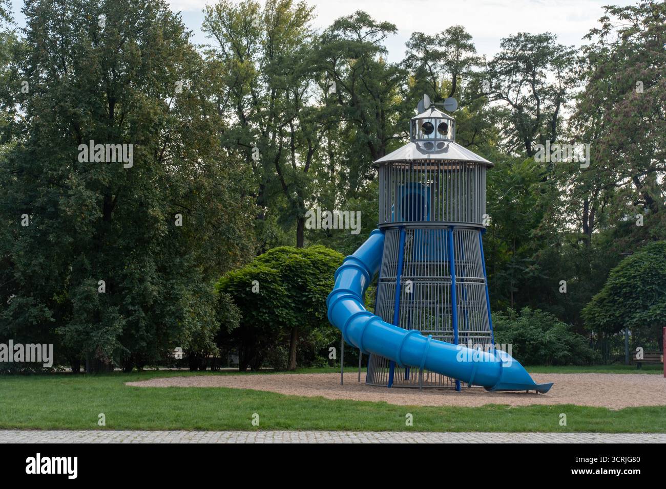Large lighthouse-shaped playground tower with blue spiral slide ...