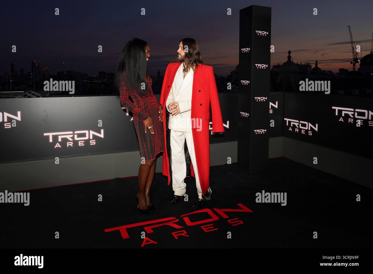 Jodie Turner-Smith, left, and Jared Leto pose for photographers upon ...