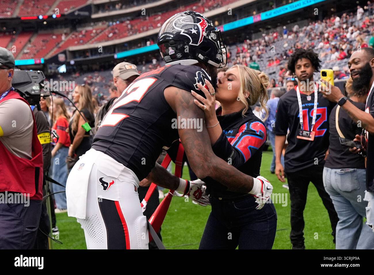 Houston Texans wide receiver Nico Collins kisses Sam Roy before an NFL ...