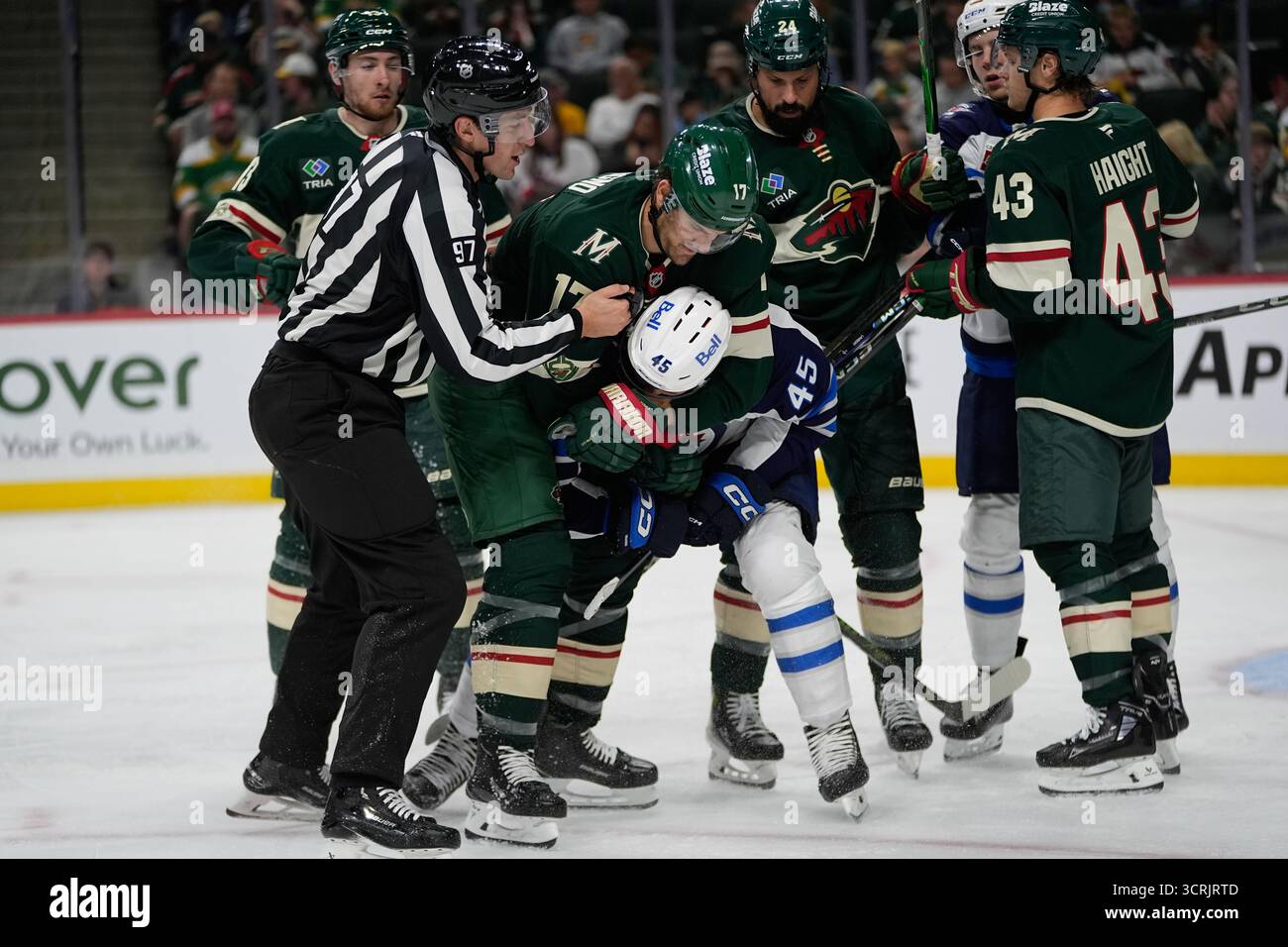 Minnesota Wild left wing Marcus Foligno (17) grabs Winnipeg Jets left ...