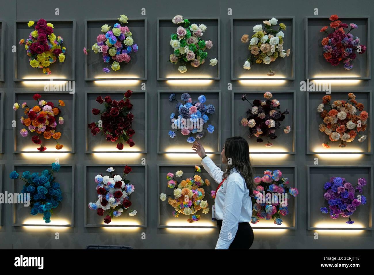 A vendor shows off carnations and roses during Proflora, a biennial ...