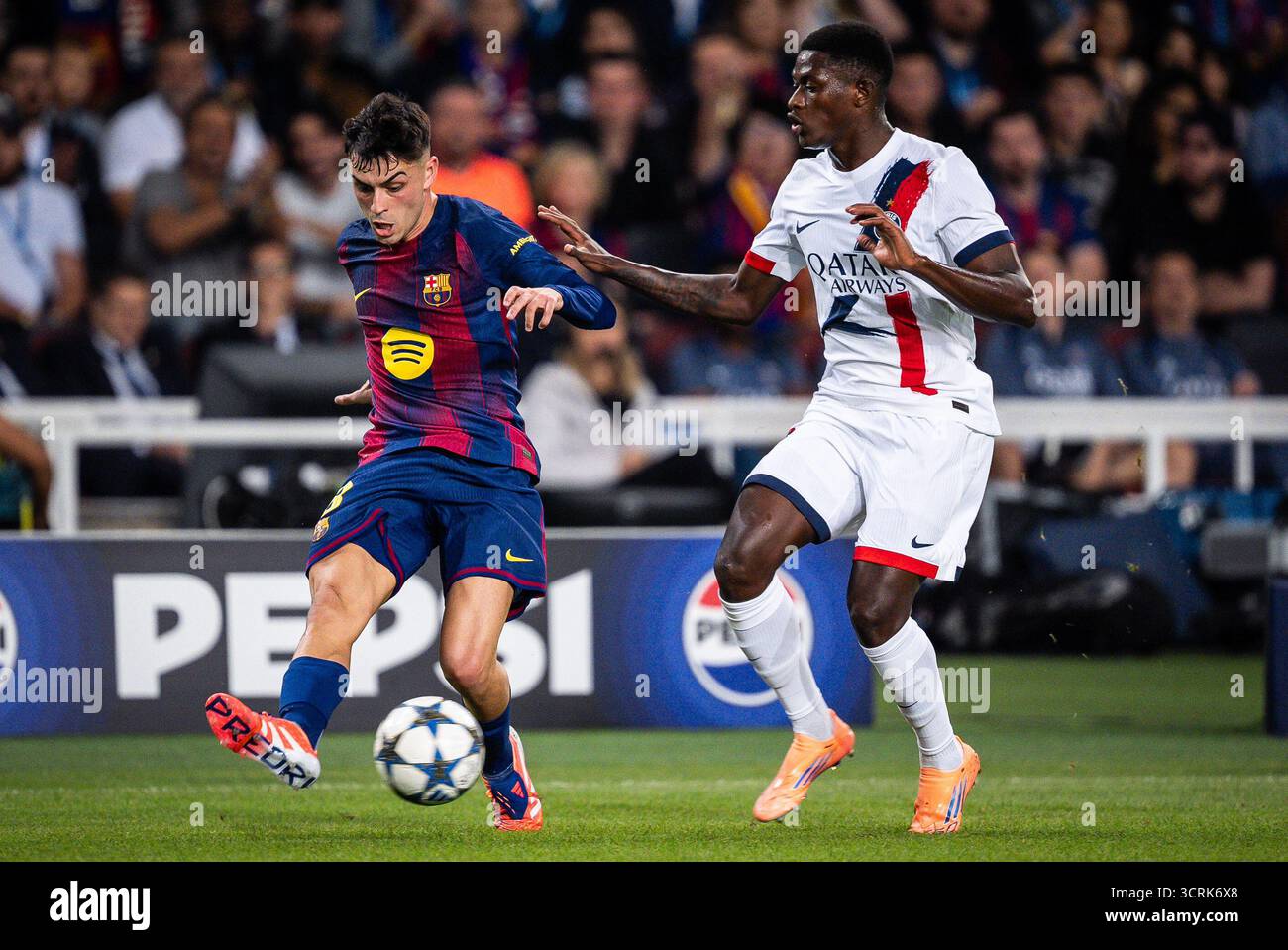 Pedro GONZALEZ LOPEZ (Pedri) of Barcelona and Nuno MENDES of PSG during ...
