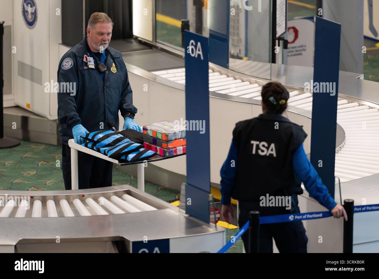 Transportation Security Administration workers talk at a security ...