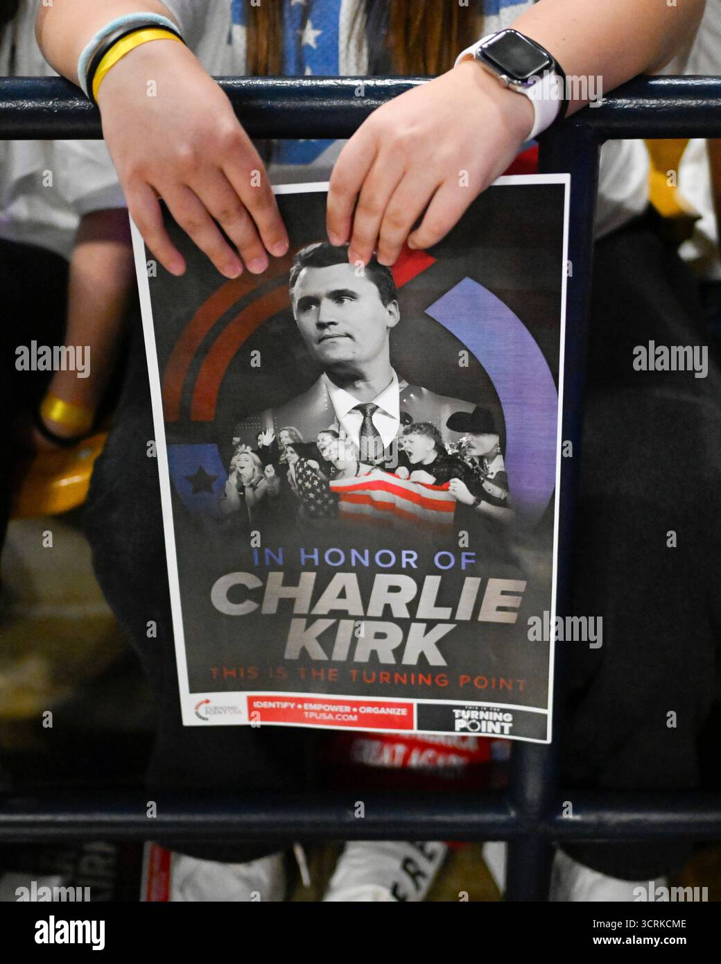 People hold posters of Charlie Kirk during a Turning Point USA rally at ...