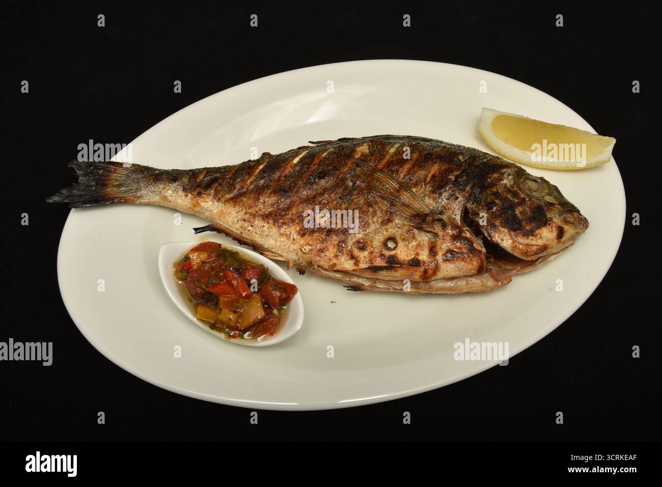 a dorada fish (royal bream), also known as golden-headed bream, grilled ...