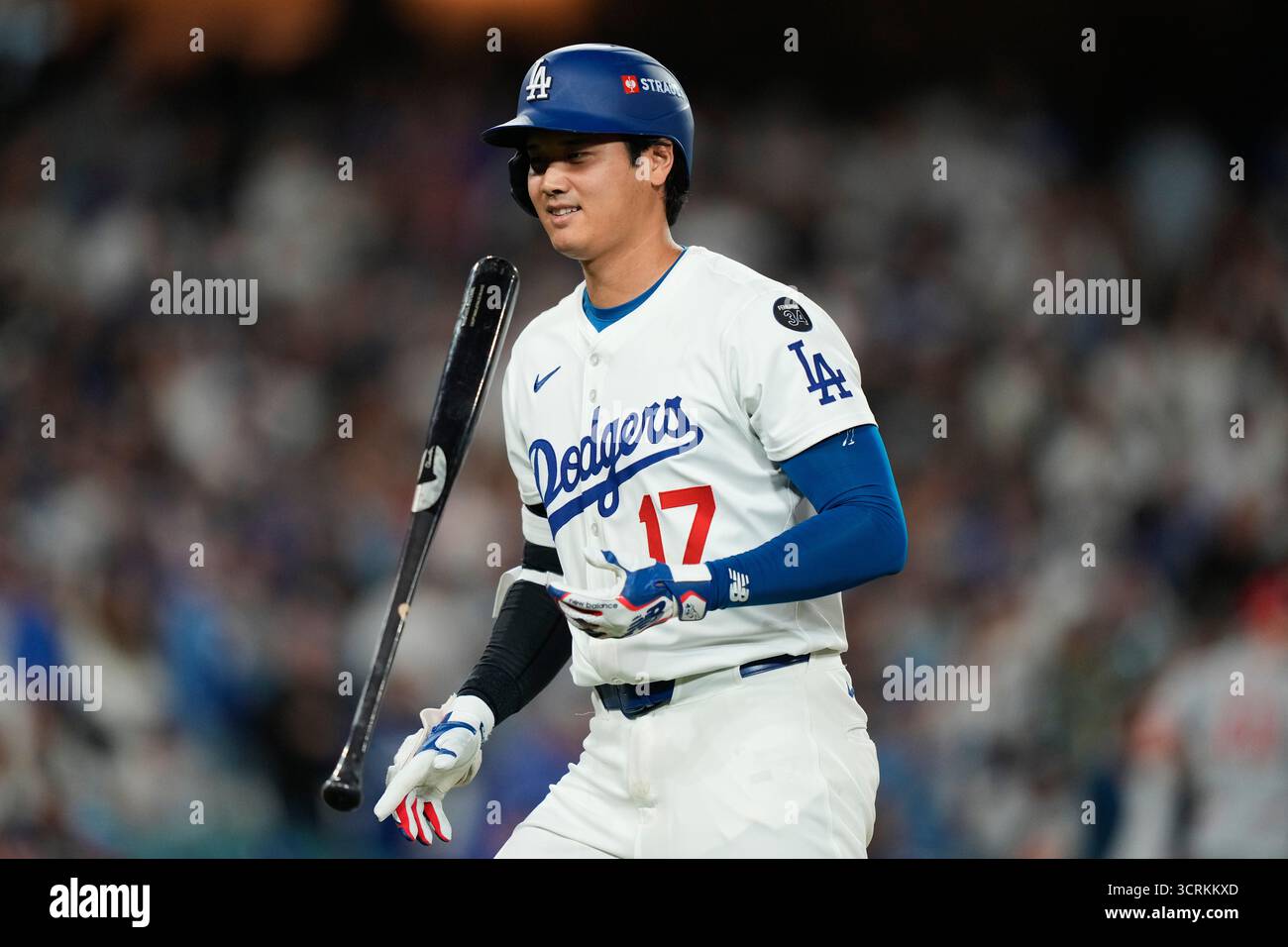 Los Angeles Dodgers' Shohei Ohtani flips his bat as he flies out during the fourth inning in ...