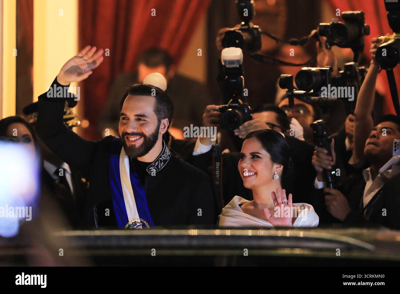 FILE - El Salvador's President Nayib Bukele, left, waves next to first ...