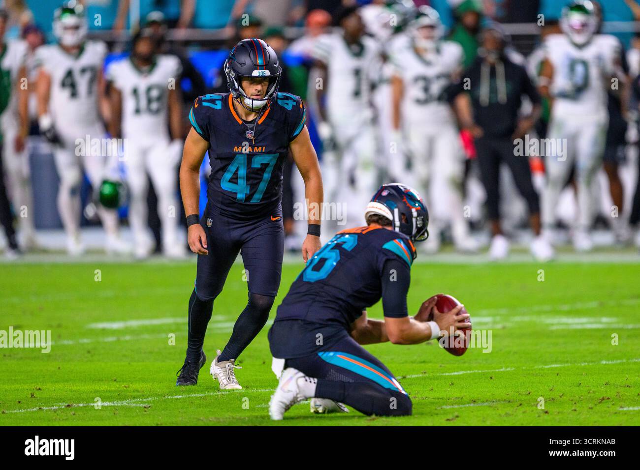 Miami Dolphins punter Jake Bailey (16) holds the ball as kicker Riley ...