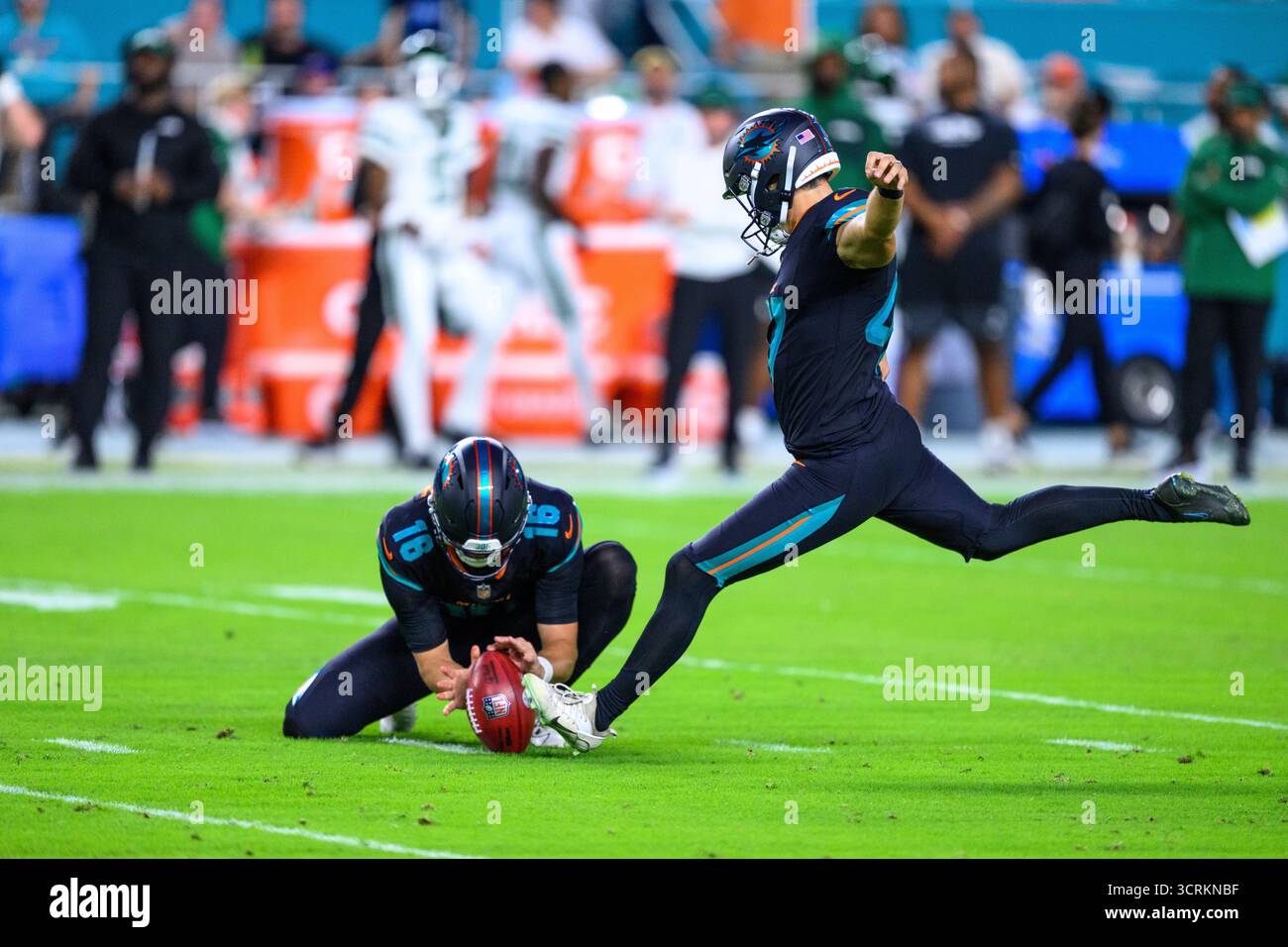 Miami Dolphins punter Jake Bailey (16) holds the ball as kicker Riley ...