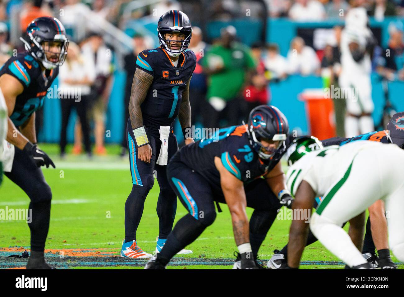 Miami Dolphins quarterback Tua Tagovailoa (1) prepares to take the snap ...