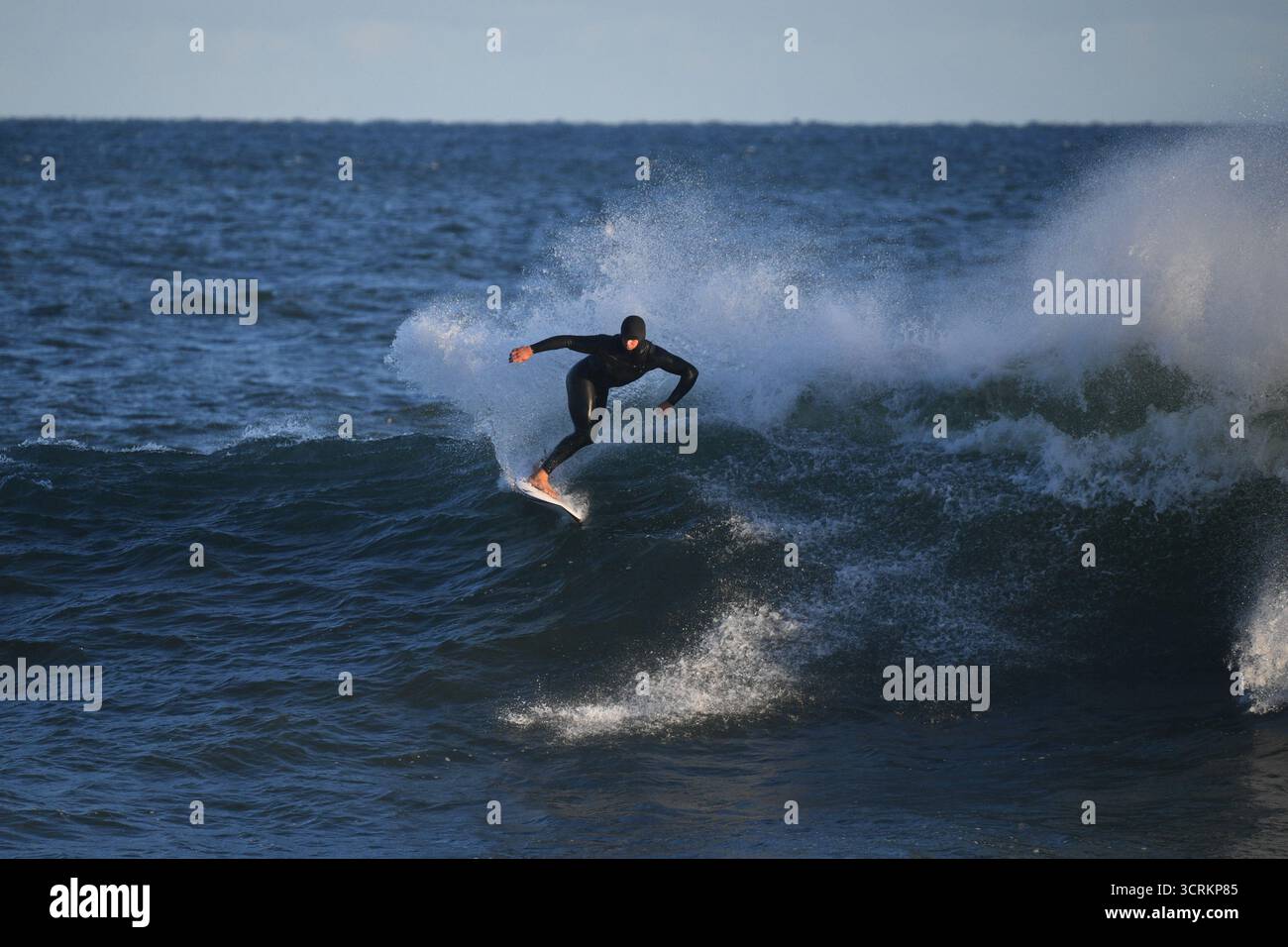 NEWPORT, RI - OCTOBER 01: A surfer rides a wave on October 1, 2025, at ...