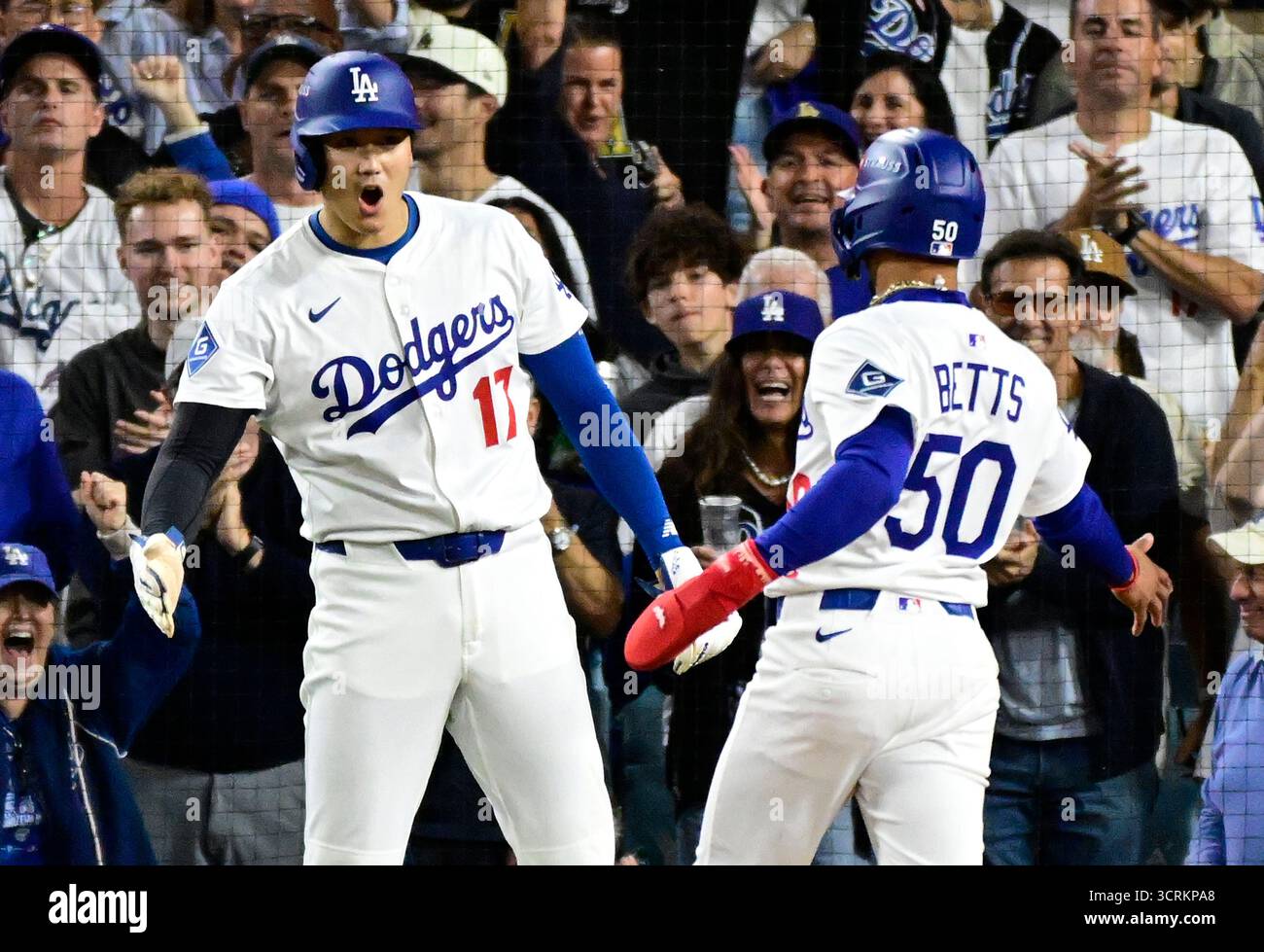 Los Angeles Dodgers designated hitter Shohei Ohtani (17) congratulates ...
