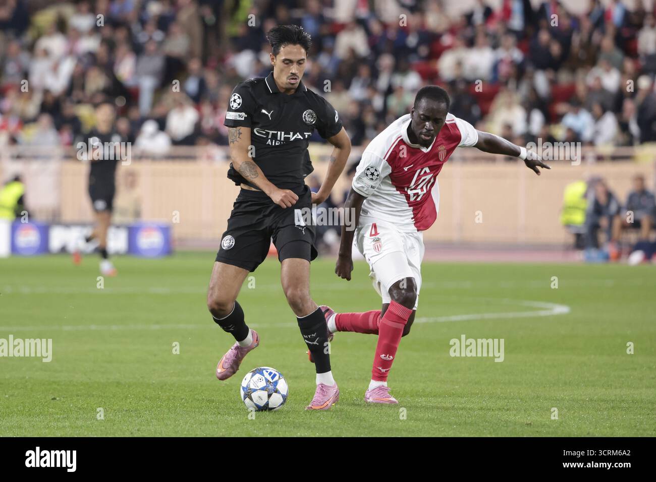 Tijjani Reijnders of Manchester City, Jordan Teze of Monaco during the ...