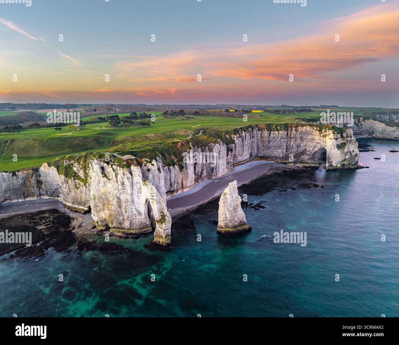 Aerial view of dramatic white cliffs meet the turquoise sea under a ...