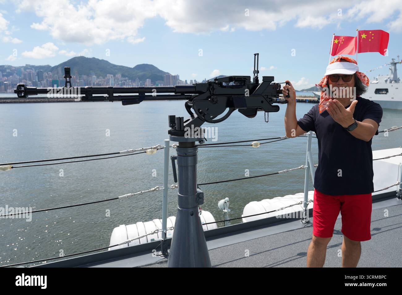 A man take photos with PLA weapon on the deck of the Chinese PLA Navy ...