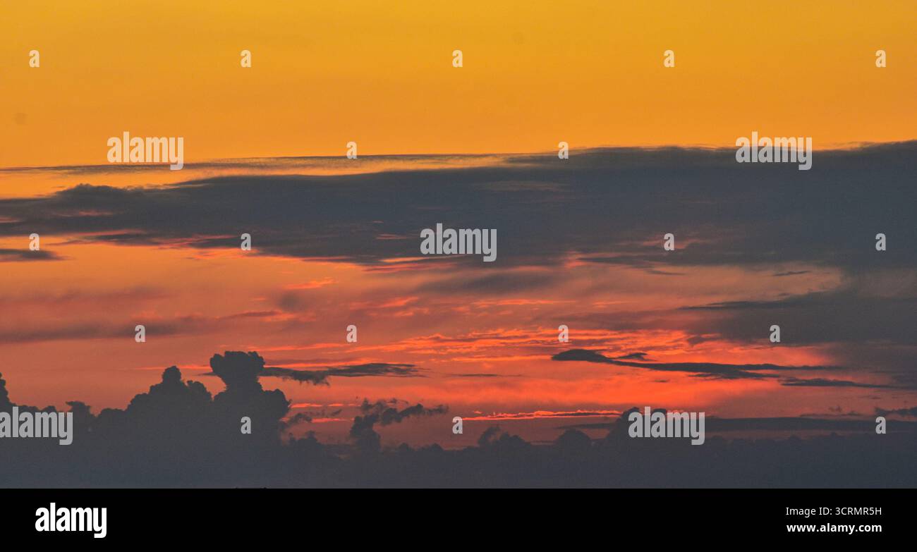 Majestic sky glowing in warm sunset tones with light, airy clouds ...