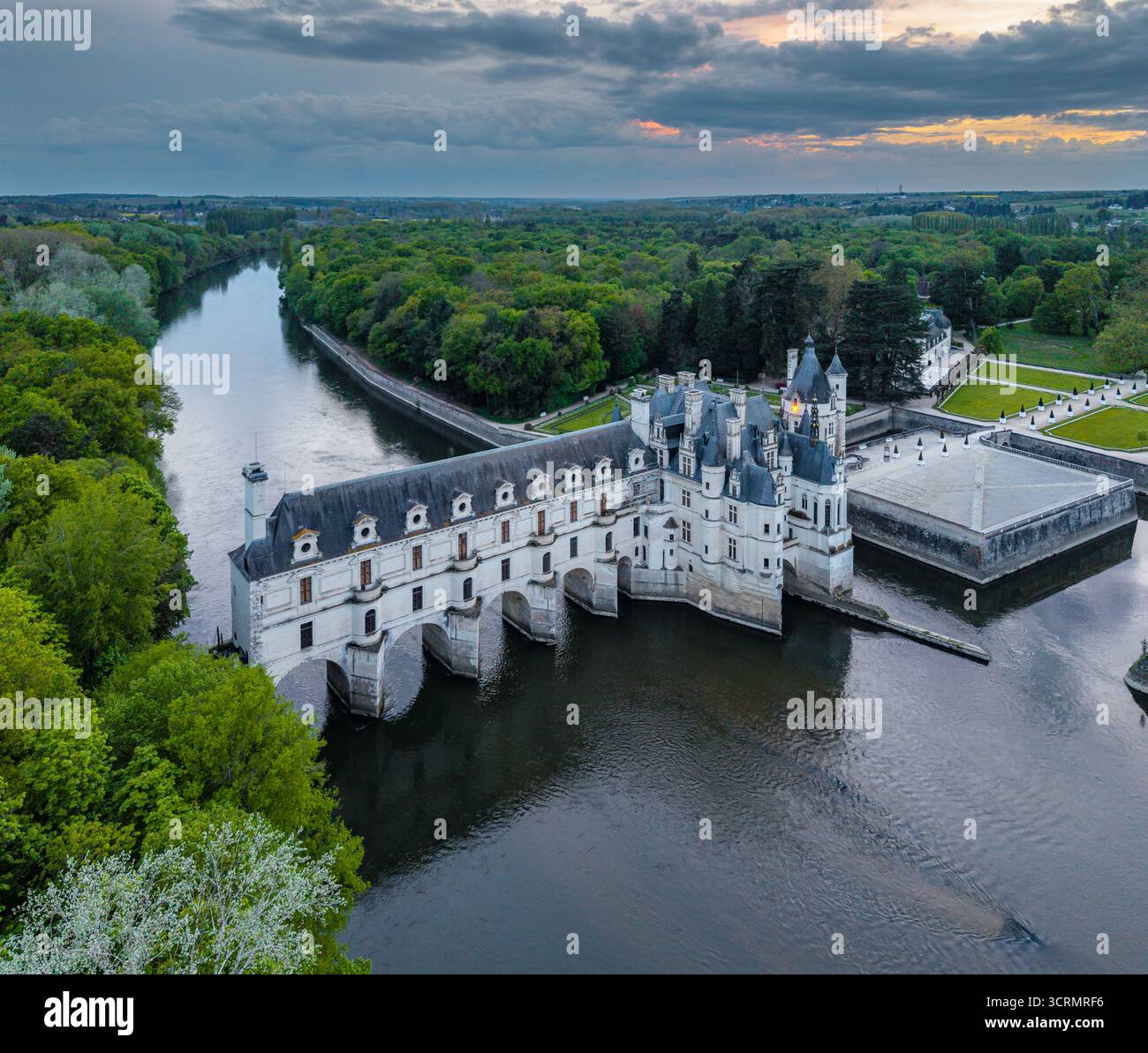 Aerial view of Château de Chenonceau mirrored in the tranquil waters, a ...
